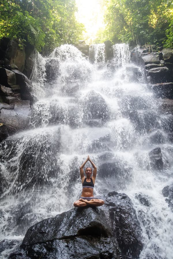 Woman Practices Yoga Near Waterfall in Bali, Indonesia Stock Photo ...