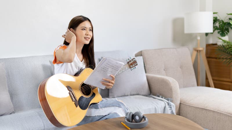 Woman Practicing or Learning To Play Guitar and Practice Using His ...