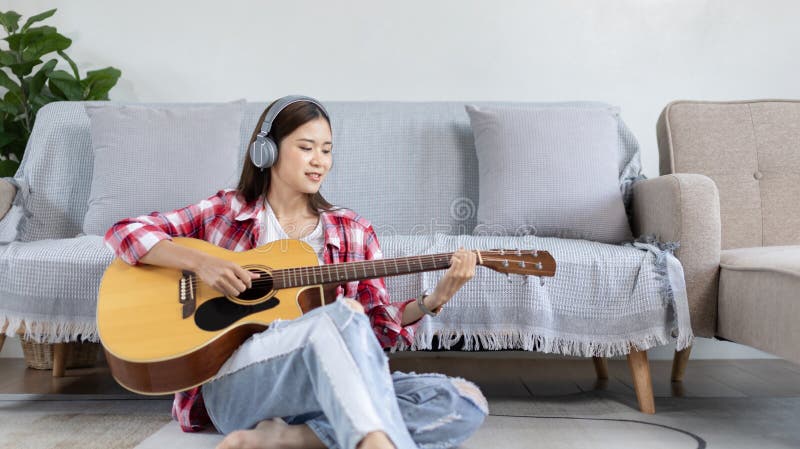 Woman Practicing or Learning To Play Guitar and Practice Using His ...