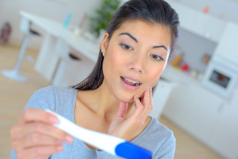 Woman with pregnancy test stock image. Image of result - 124014049