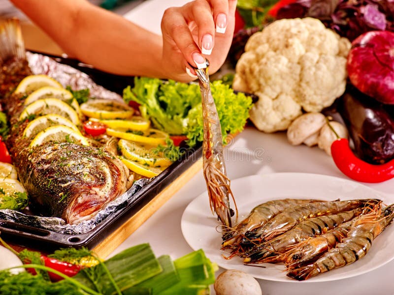 Woman prepare fish in oven stock image. Image of seafood - 54817587