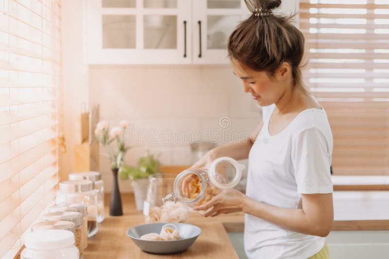 Woman Preparing Breakfast in the Kitchen in the Morning. Stock Image ...