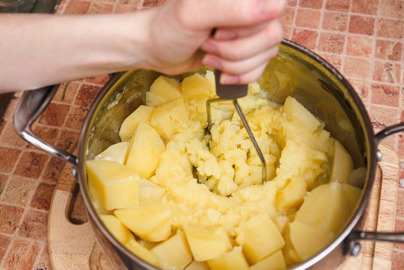 Woman Preparing Mashed Potatoes with Stainless Potato Masher. Cooking ...