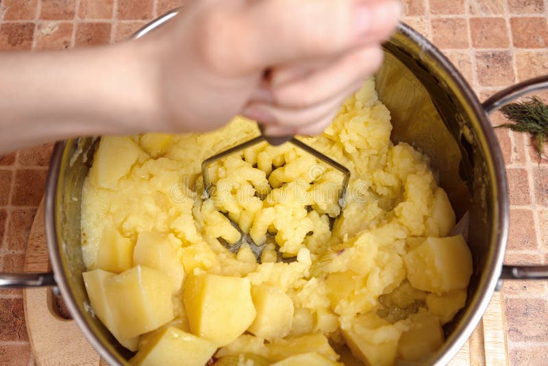 Woman Preparing Mashed Potatoes with Stainless Potato Masher. Cooking ...