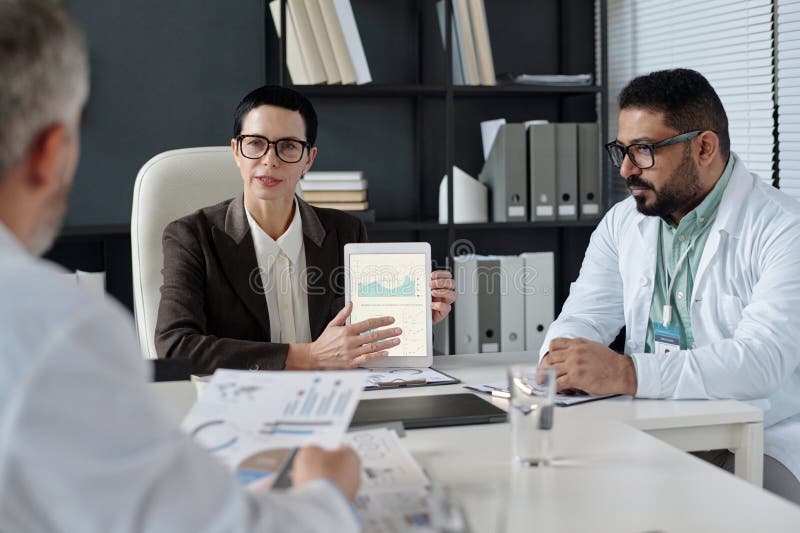 Woman Presenting Data Report at Conference Pointing at Statistics Graph ...