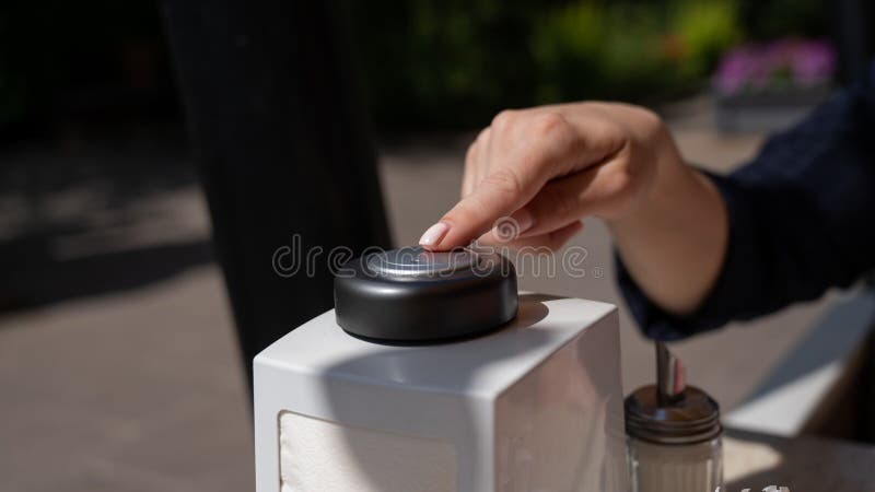 Woman Pressing Button To Call Waiter in Cafe. Stock Image - Image of ...