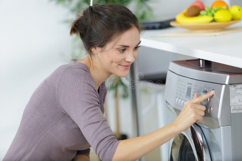 Woman Pressing Button To Start Washing Machine Stock Photo - Image of ...