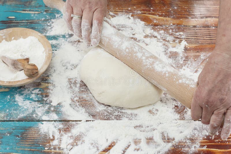 Woman Pressing Dough with Rolling Pin Stock Photo - Image of food ...