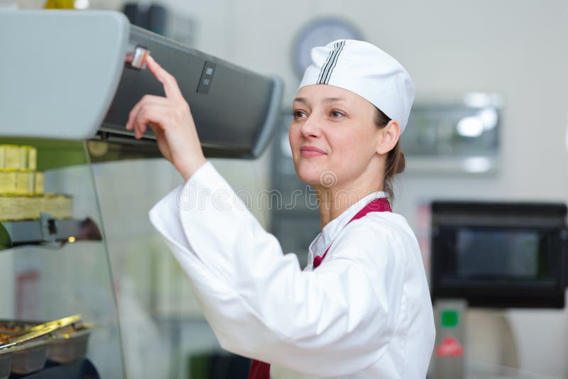 Woman Pressing Switch on Food Cabinet Stock Image - Image of woman ...