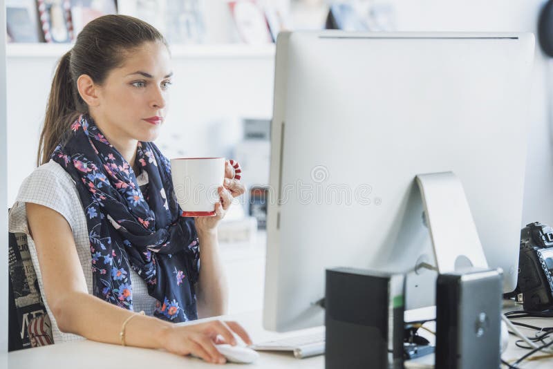 Woman Professional is Using a Computer Drinking a Beverage Stock Image ...