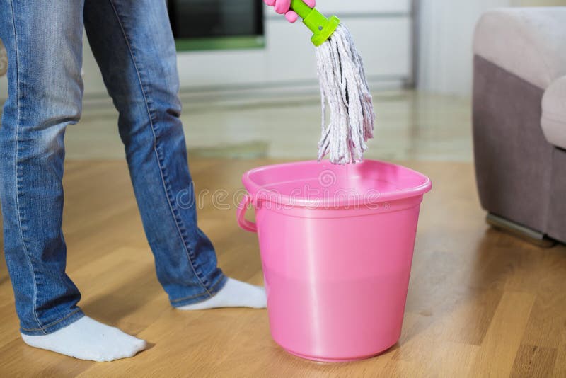 Woman In Protective Gloves Using A Wet Mop While Cleaning Floor Stock