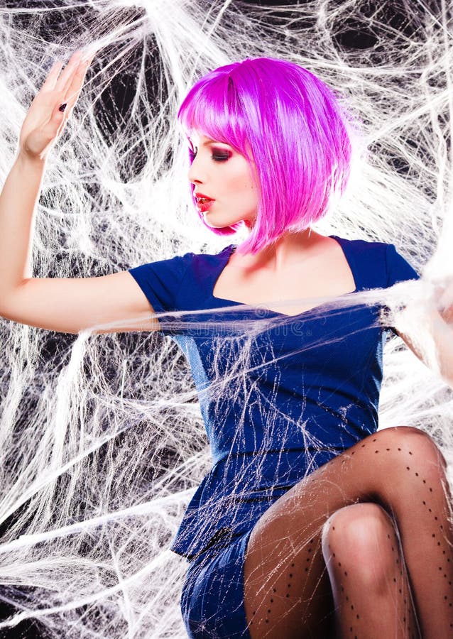 Woman with Purple Wig and Intense Make-up Trapped in a Spider Web Stock ...