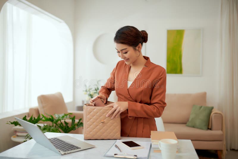 A Woman Puts Essential Things in a Bag Stock Photo - Image of leather ...