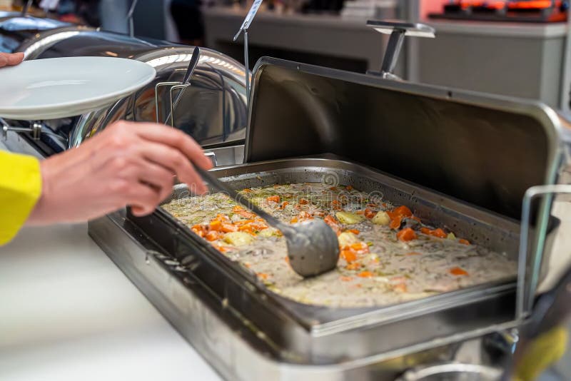 Woman Puts Food on Her Plate at the Buffet. Stock Photo - Image of ...