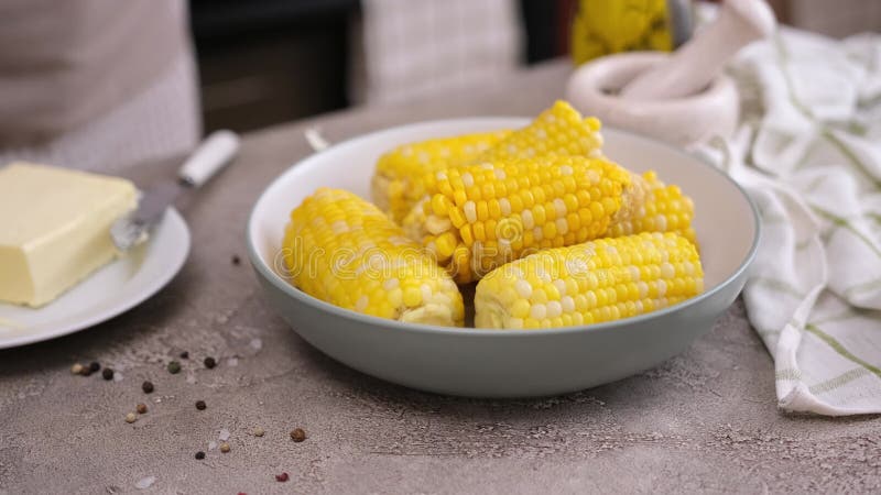 Woman Puts Plate with Freshly Cooked Corn on a Table Stock Footage ...