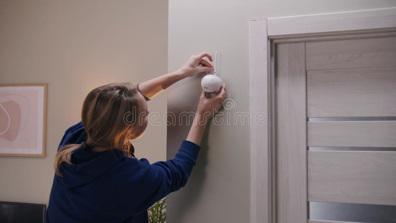 Woman Puts Security Camera on Wall Mount Stock Video - Video of ...