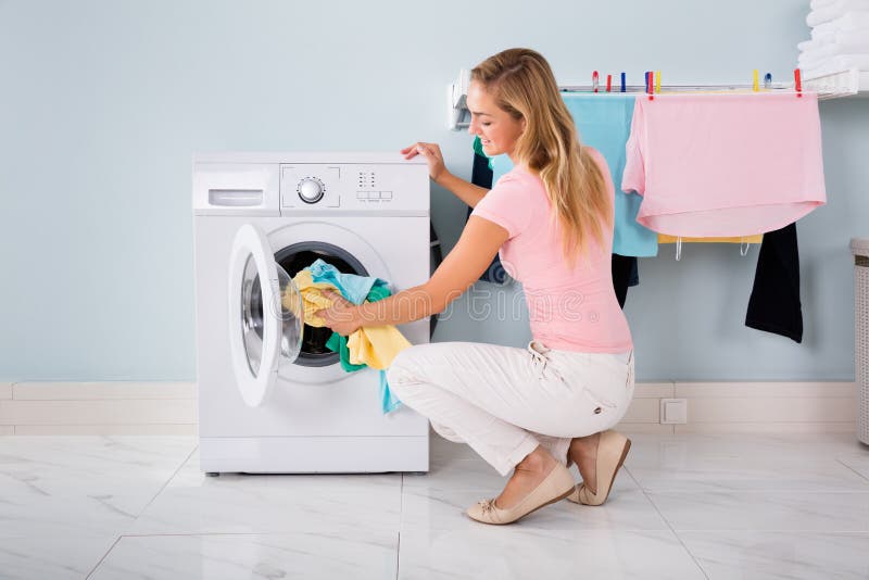 Woman Putting Clothes in Washing Machine Stock Image - Image of ...