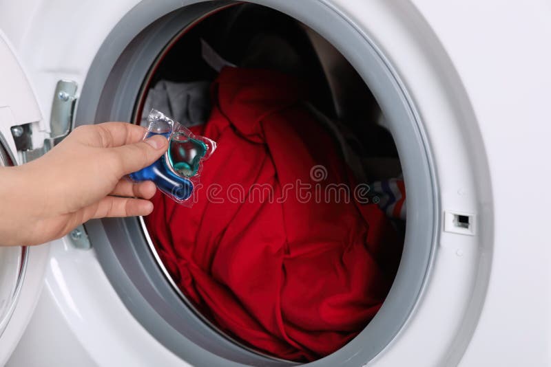 Woman Putting Laundry Detergent Capsule into Washing Machine, Closeup ...