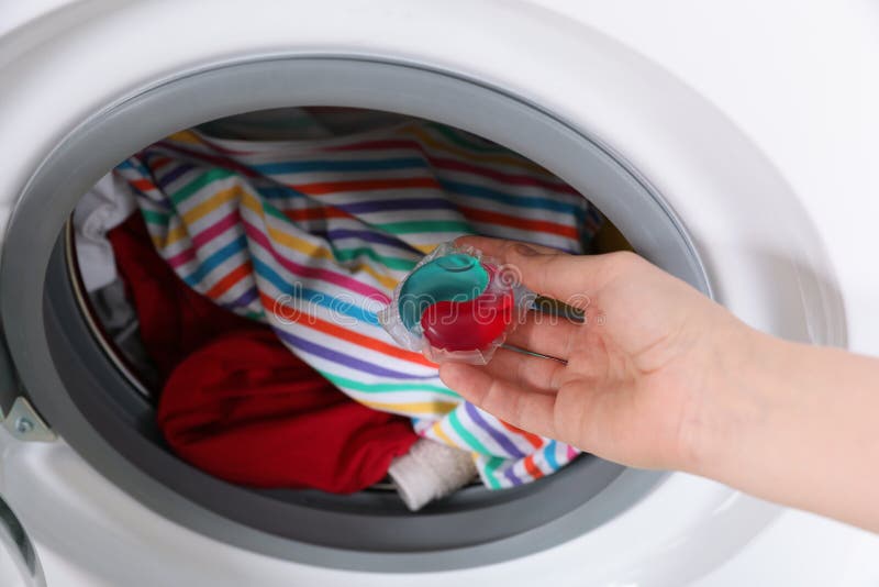 Woman Putting Laundry Detergent Capsule into Washing Machine, Closeup ...