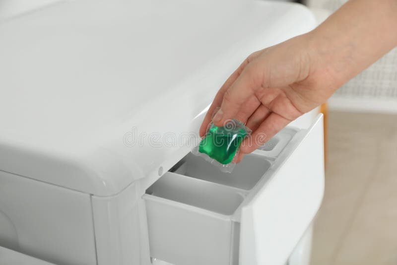 Woman Putting Laundry Detergent Capsule into Washing Machine Closeup ...