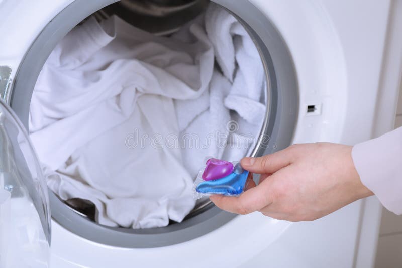 Woman Putting Laundry Detergent Capsule into Washing Machine, Closeup ...