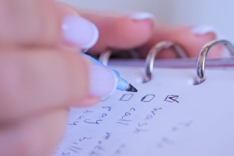Woman Putting Mark on Check Boxes of To Do List in Notebook - Close Up ...