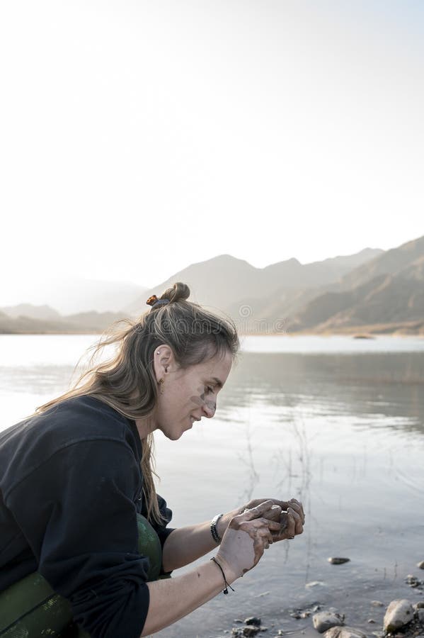 Woman Putting Mud on Hands and Face while Enjoying Outdoors in Nature ...