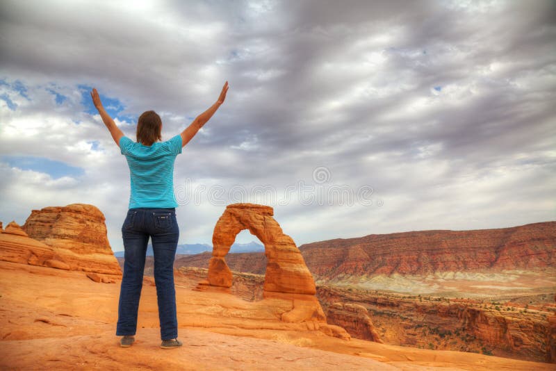 Woman with Raised Hands in Front of Delicate Arch Stock Image - Image ...