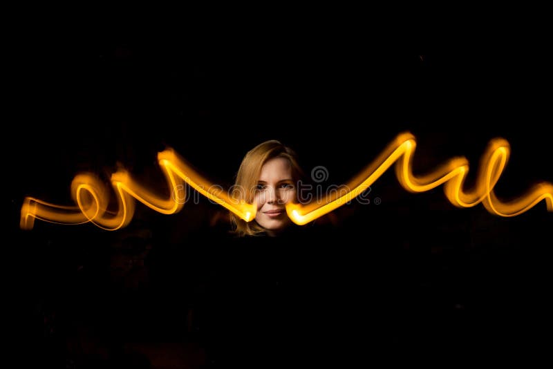 A Woman with Rays of Energy Emanating from Her Head in the Dark Stock ...