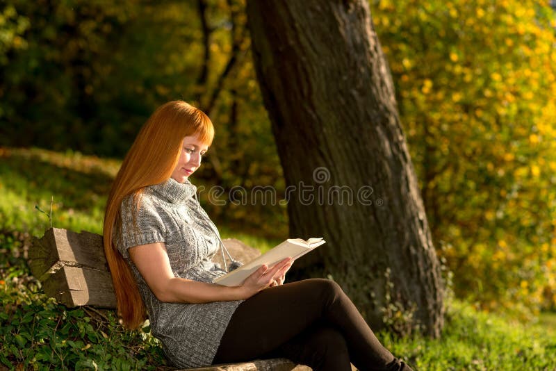 Reading a Book in the Spring Sun Stock Photo - Image of dress, park ...