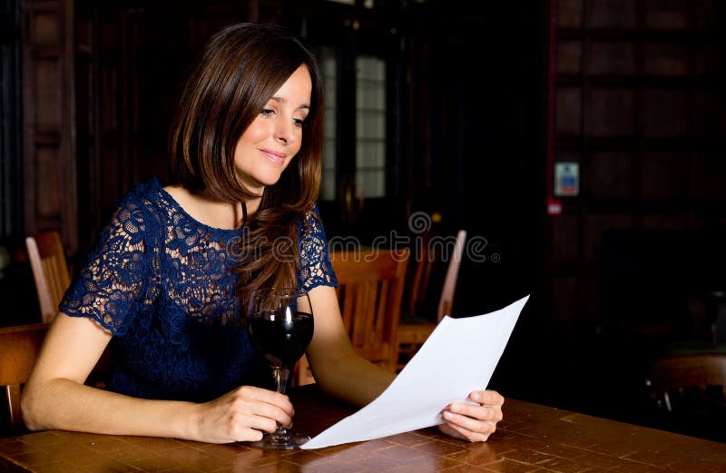 Woman reading in a bar stock image. Image of caucasian - 46546331