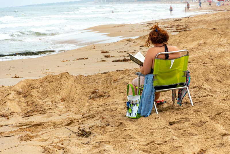 Woman Reading on a Beach in Alicante. Spain Editorial Photography ...