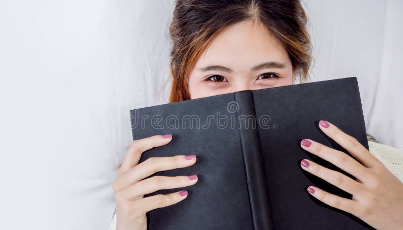 Woman Reading on Bed. Looking at Camera with Charming Eyes Stock Image ...