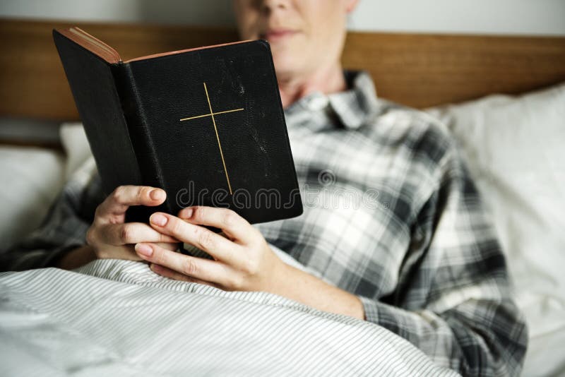 A woman reading a bible stock photo. Image of person - 109712062