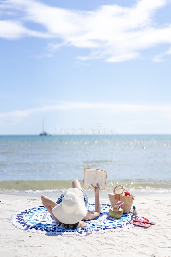 Woman is Reading a Book on Beach Stock Photo - Image of beautiful, blue ...