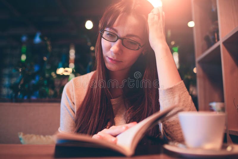 Woman Reading a Book in Cafe. Closeup. Stock Image - Image of brunette ...