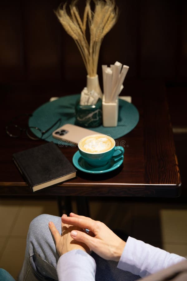Woman Reading a Book and Drinking Coffee at Restaurant Stock Photo ...