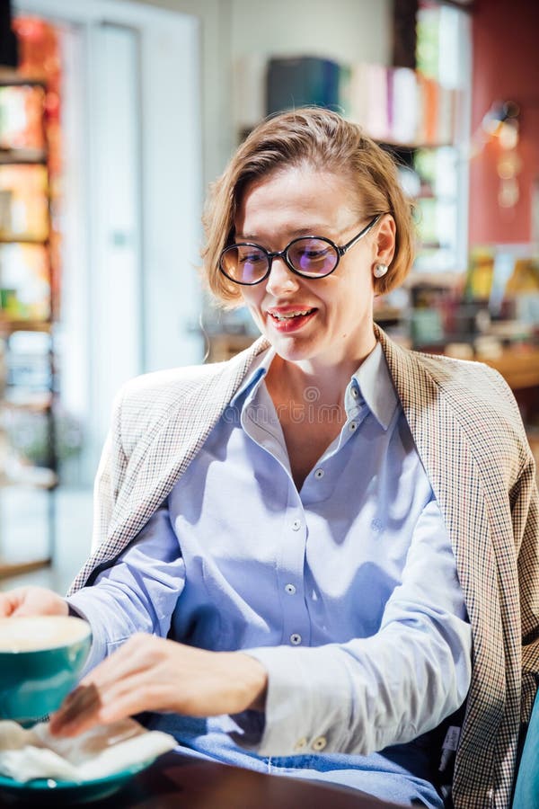 Woman Reading a Book and Drinking Coffee at Restaurant Stock Image ...