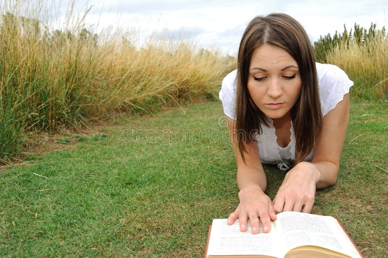 Woman Reading Book on Field Stock Image - Image of outside, landscape ...