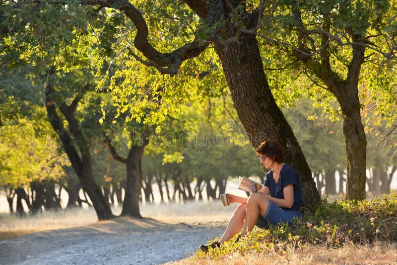 Woman Reading a Book in Forest Stock Image - Image of gold, smiling ...