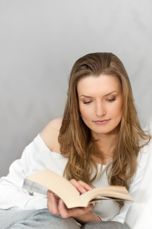 Woman Reading Book at Home and Relaxing Stock Photo - Image of grinning ...