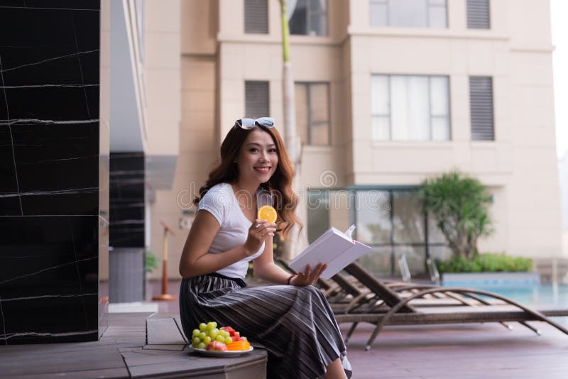 Woman Reading a Book Near the Water Pool Stock Photo - Image of sunny ...