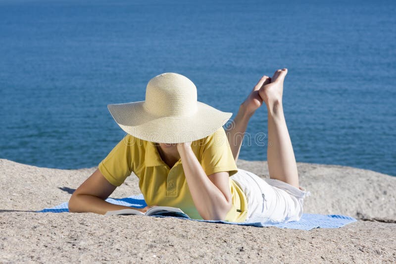 Woman Reading a Book at the Sea Stock Photo - Image of coast, beach ...