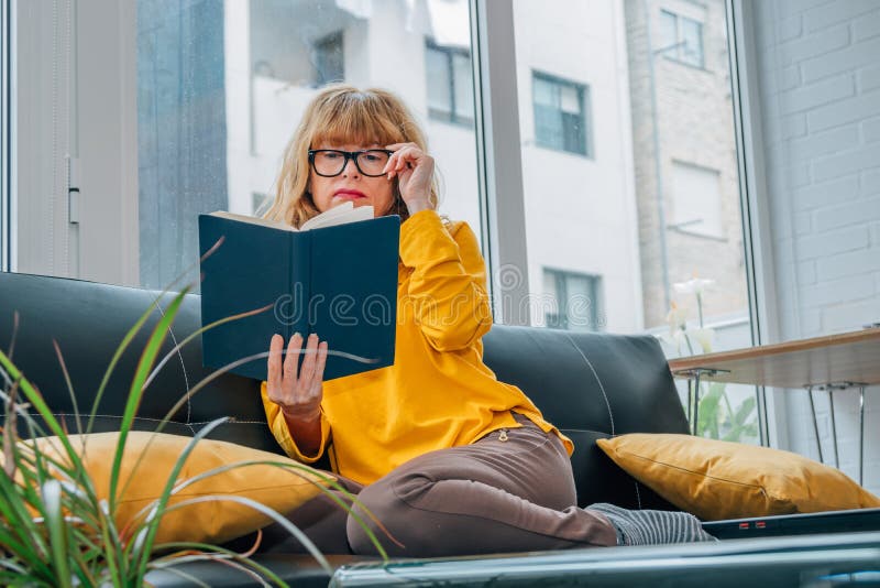Woman Reading a Book on the Sofa Stock Image - Image of sofa ...