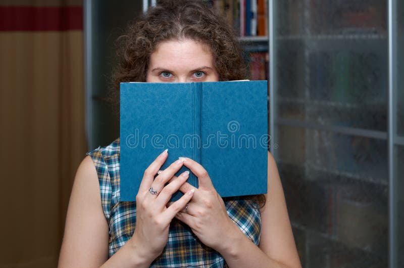 Woman Reading a Book Standing by a Bookcase Stock Image - Image of book ...