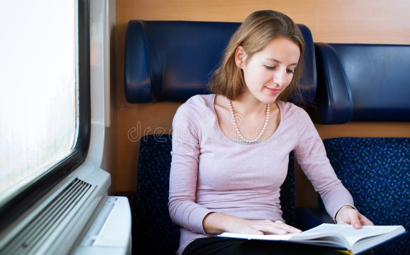 Woman Reading a Book while on a Train Stock Photo - Image of girl ...
