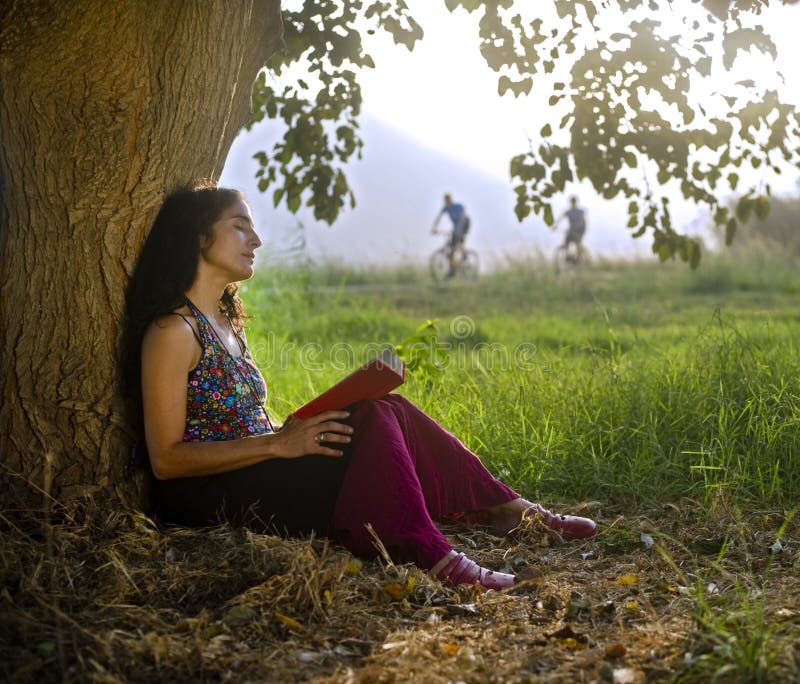 Woman Reading Book Under Tree Stock Image - Image of enjoy, three: 7056973