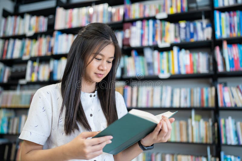A Woman is Reading a Book in the University Library Stock Image - Image ...