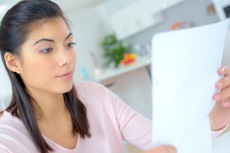 Woman Reading Document at Home Stock Image - Image of sitting, paper ...