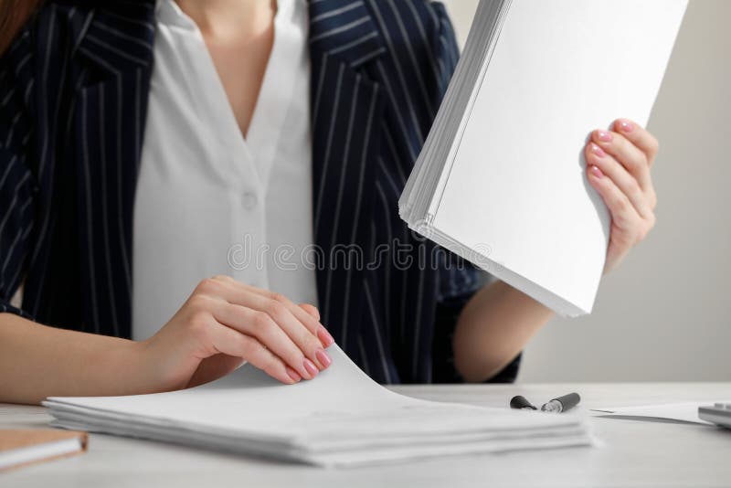 Woman Reading Documents at White Table in Office, Closeup Stock Photo ...